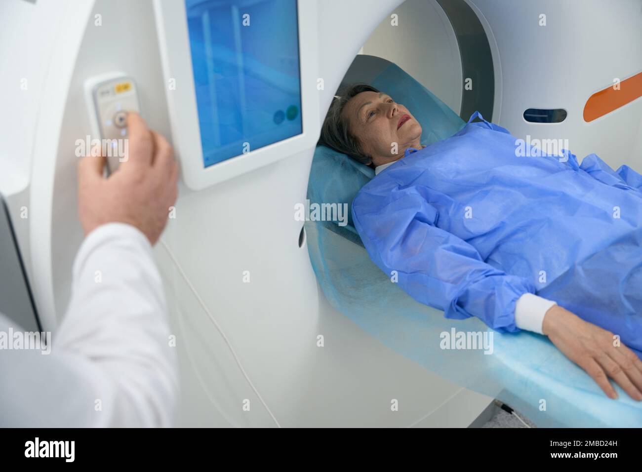 Doctor sends an elderly woman to the CT camera Stock Photo - Alamy