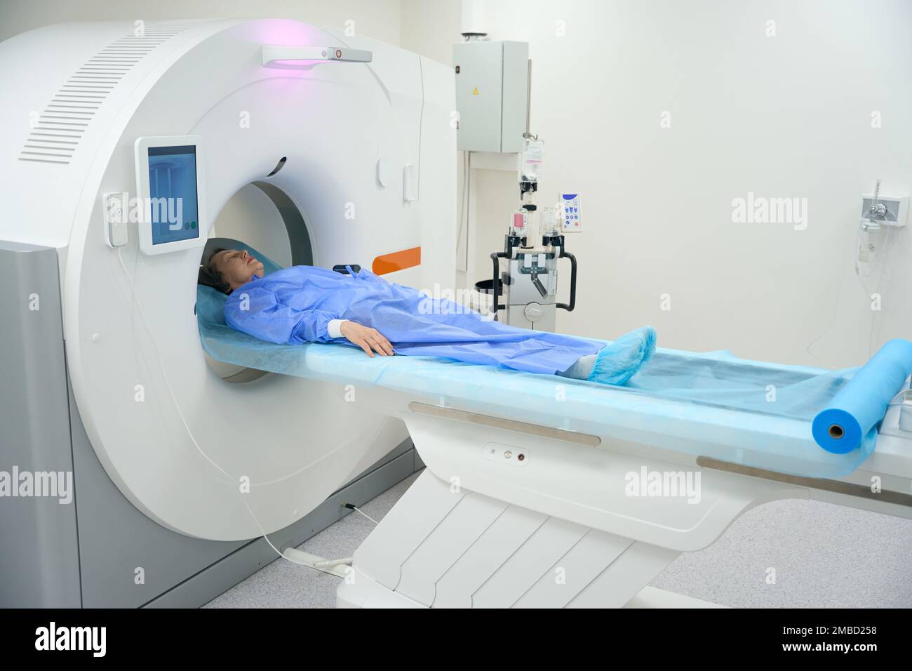 Patient undergoes an MRI diagnostic procedure using modern equipment ...