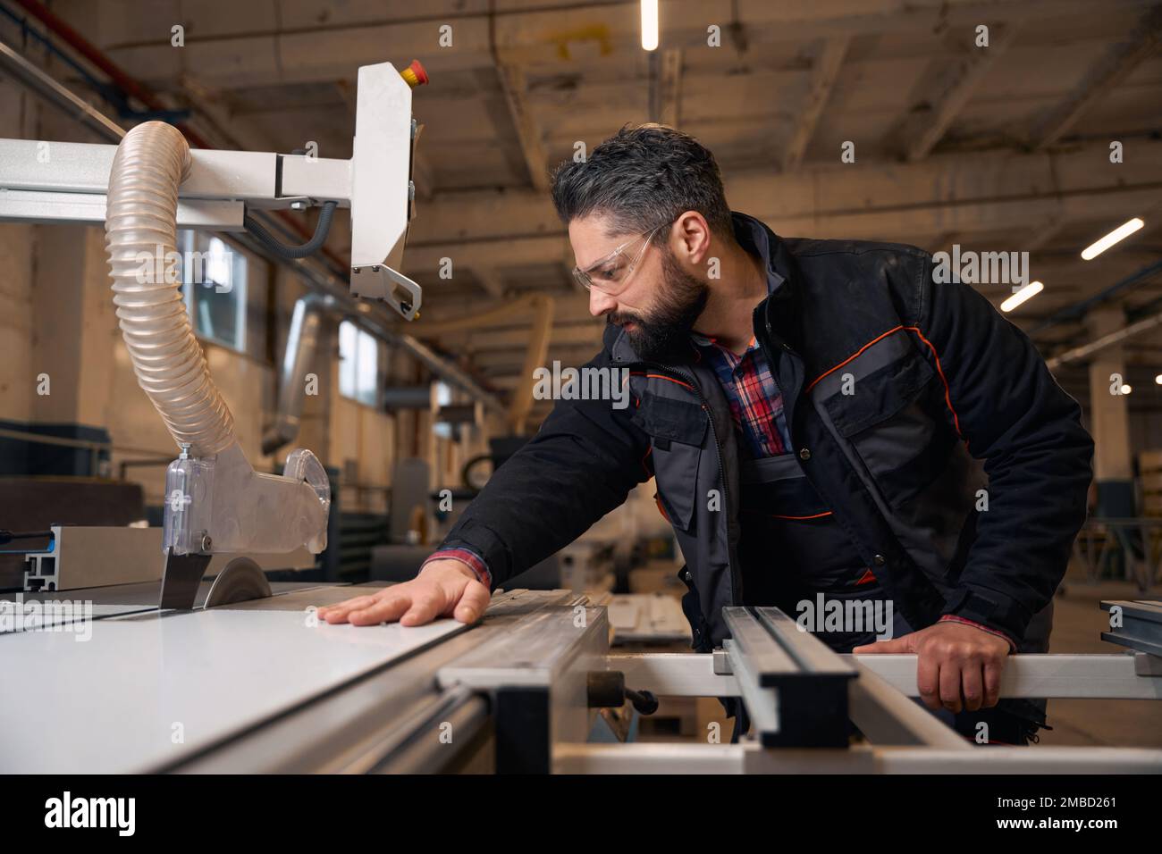 Male cutting wood in the workhouse, hard working Stock Photo - Alamy