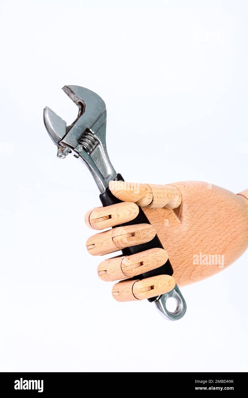 Wooden hand holding an adjustable spanner wrench Stock Photo - Alamy