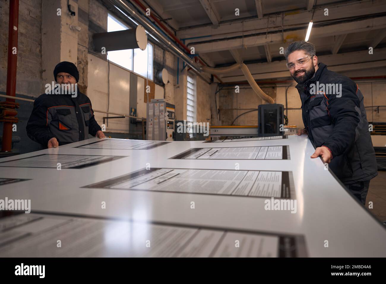 Man working inside workshop with wood, making furniture Stock Photo - Alamy