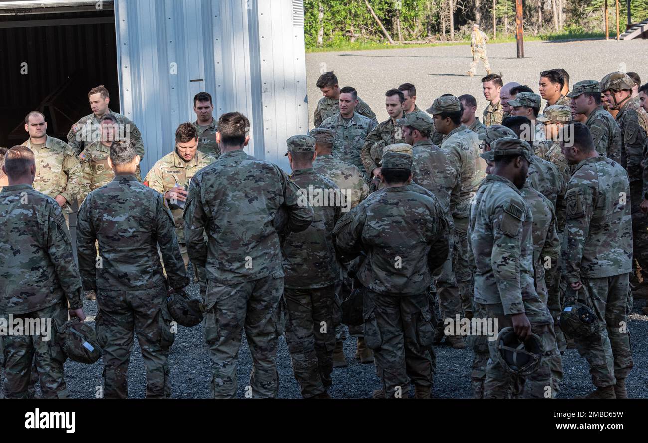 U.S. Army Soldiers and U.S. Air Force Airmen huddle after the parachute ...