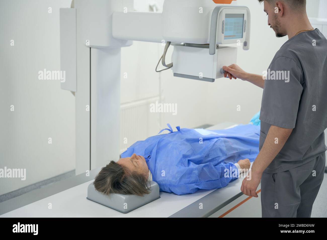 Radiologist performs a chest x-ray on an elderly patient Stock Photo ...