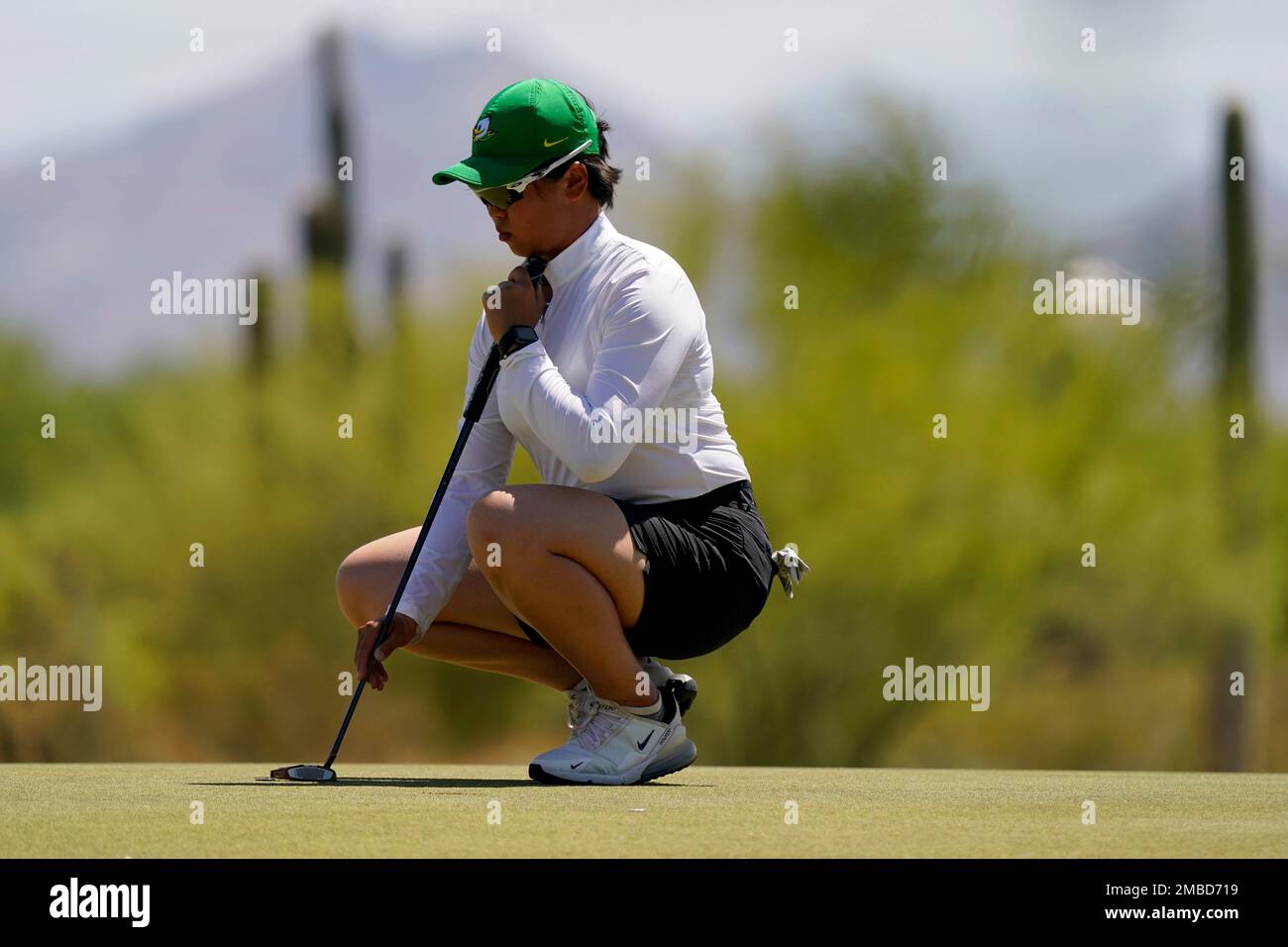 Oregon golfer Hsin-Yu Lu lines up her putt on the fourth green during ...
