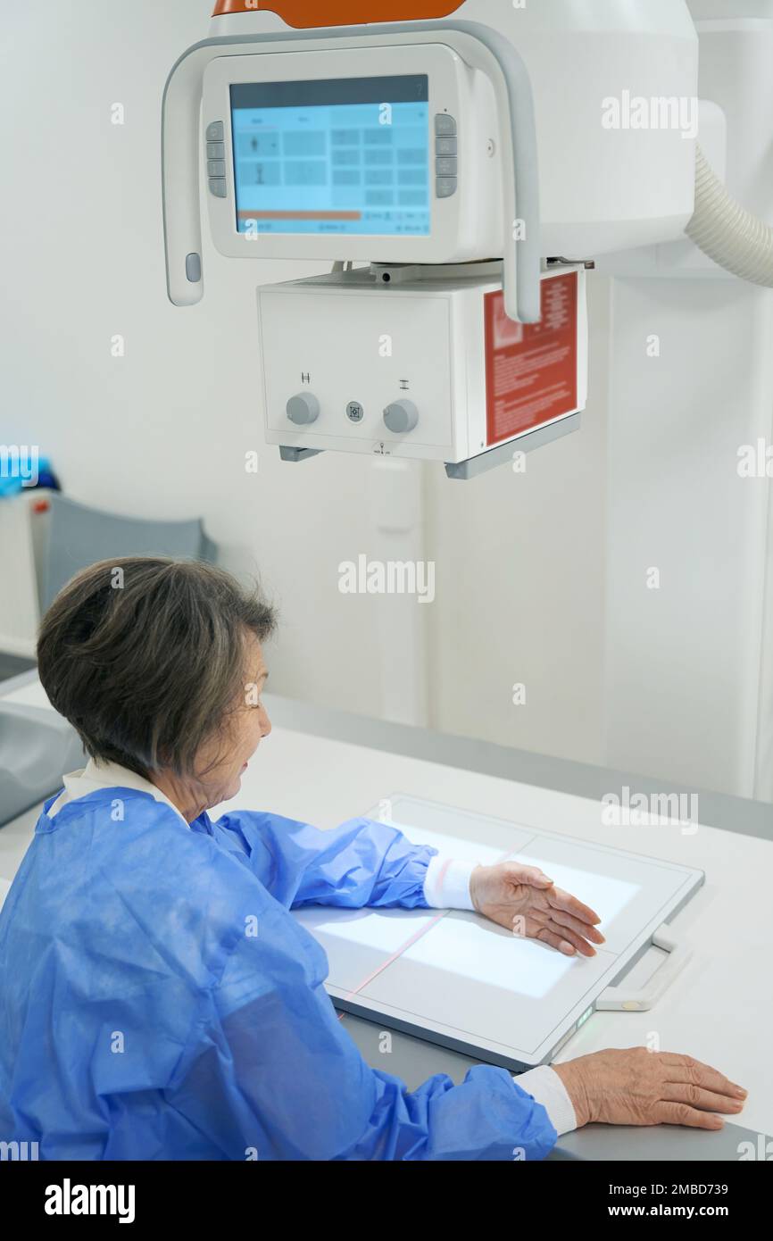 Elderly woman is sitting in the x-ray room Stock Photo - Alamy