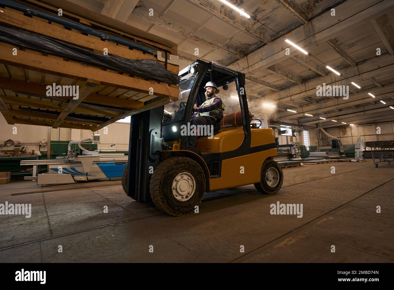 Loader transporting goods by car in the workshop Stock Photo - Alamy