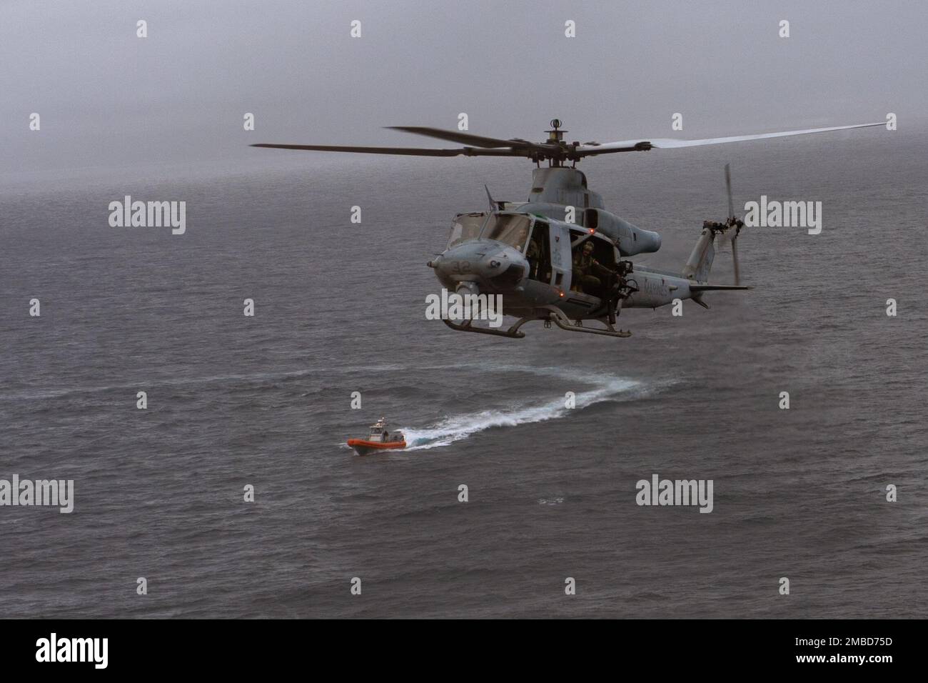 A U.S. Marine UH-1Y Huey helicopter approaches USS Miguel Keith (ESB-5 ...