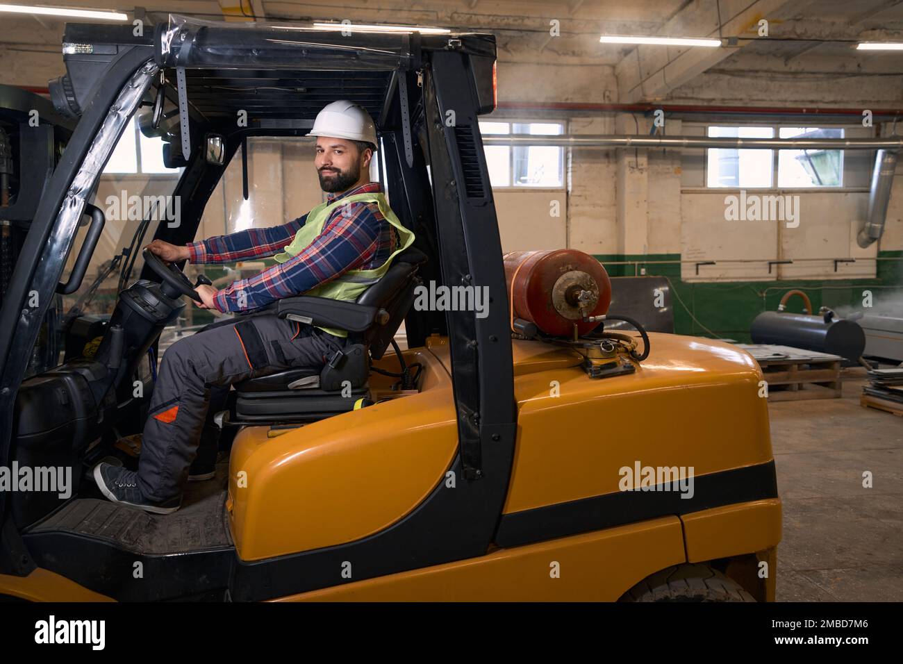 Professional loader transporting goods by car in the workshop Stock ...