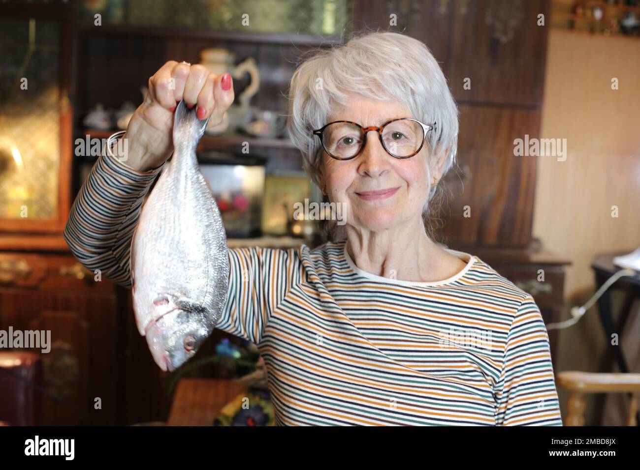Woman holding fish hi-res stock photography and images - Alamy