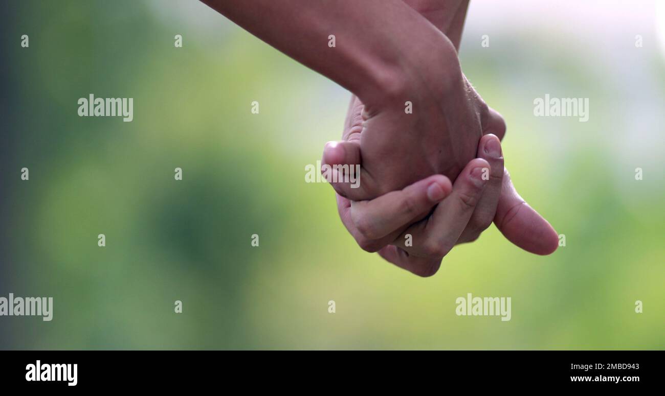 Two people holding hands close-up. Joining union between two lovers in ...