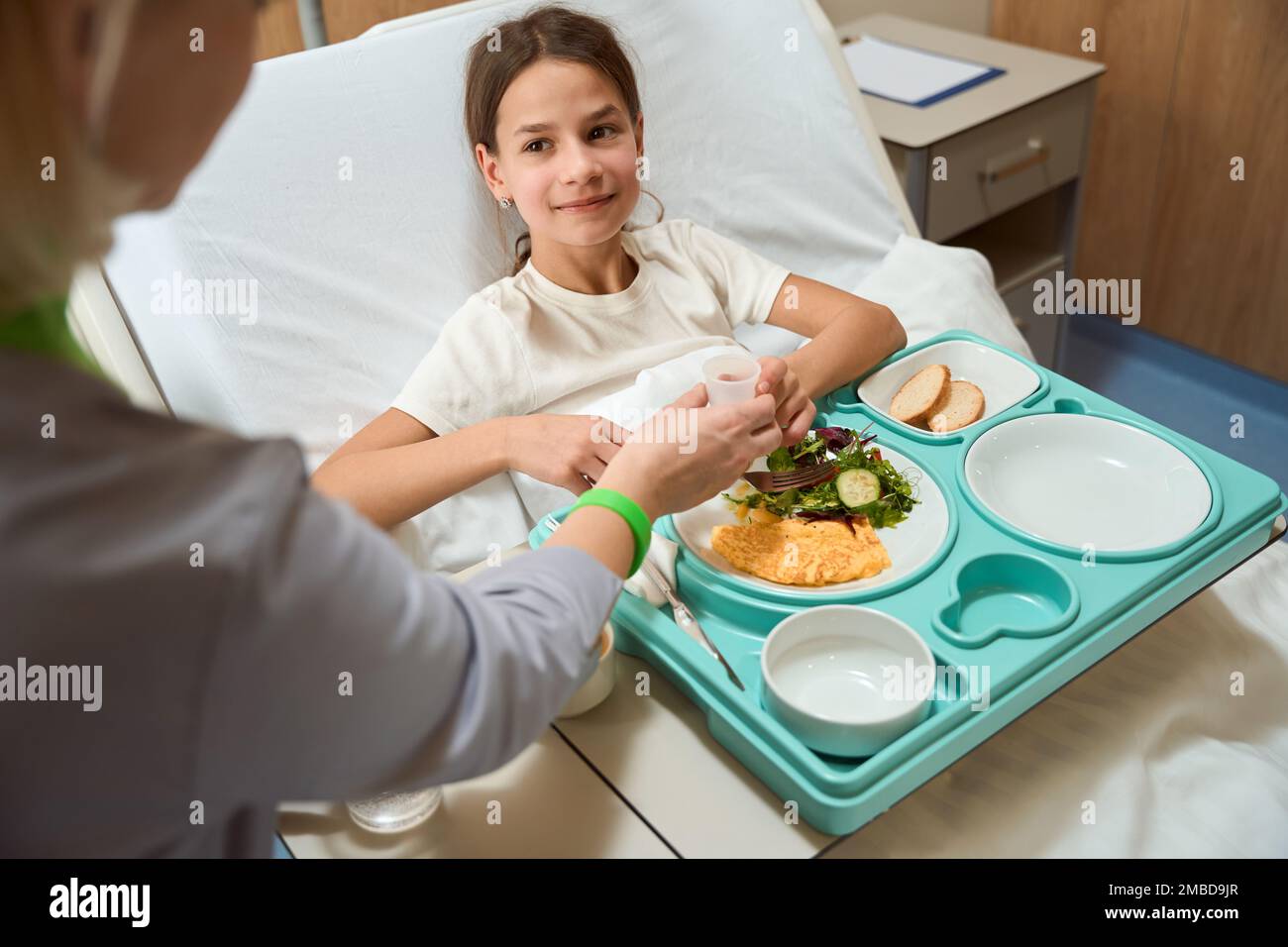 Doctor giving medicine to patient while eating Stock Photo - Alamy