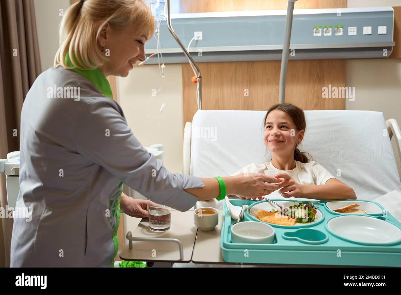 Nurse giving medicine to patient while eating Stock Photo - Alamy
