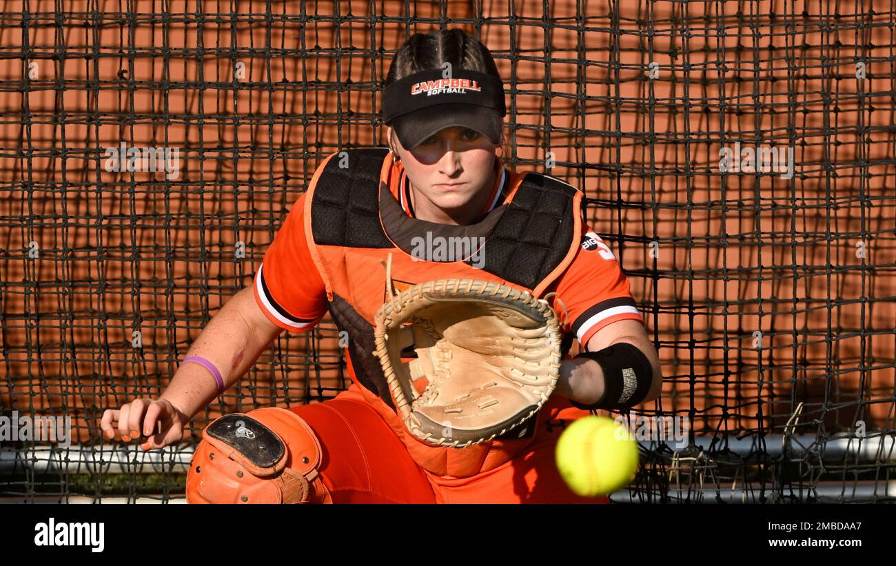 Campbell catcher Savannah White warms up for an NCAA softball game ...