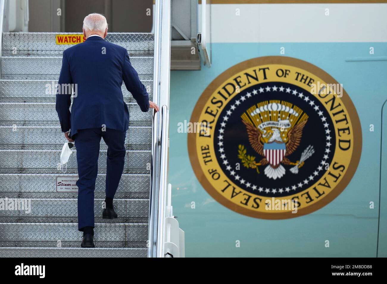 U.S. President Joe Biden walks up a staircase to Air Force One as he ...