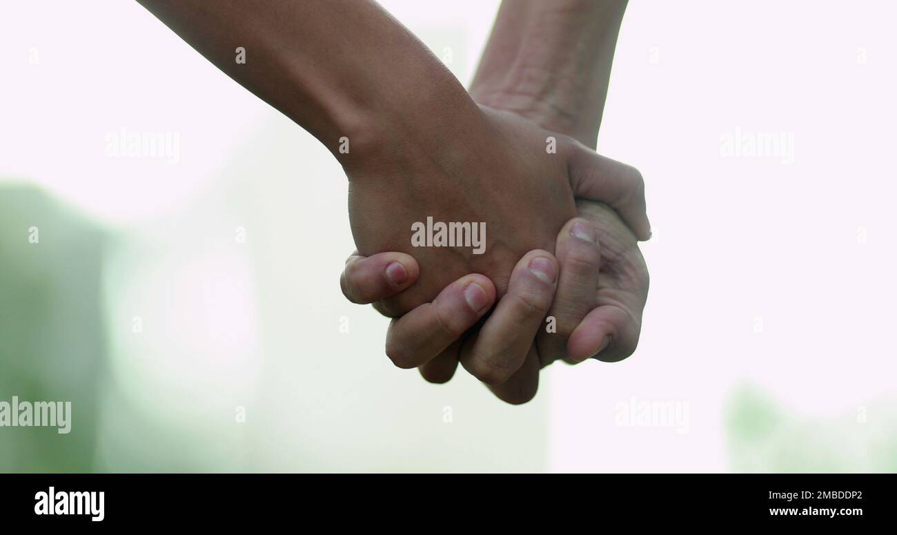 Joining hands together uniting the chain from hands held together in ...