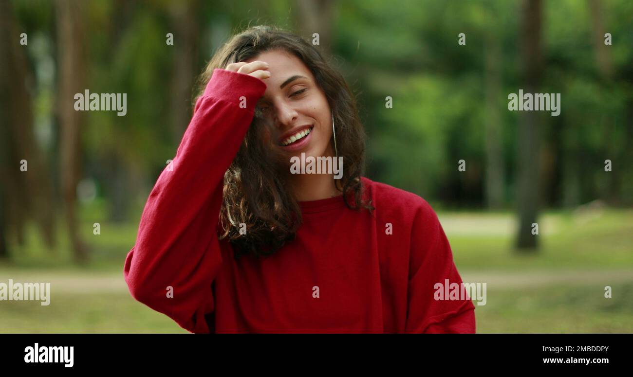 Hispanic young woman feeling pleased and happy looking to camera ...