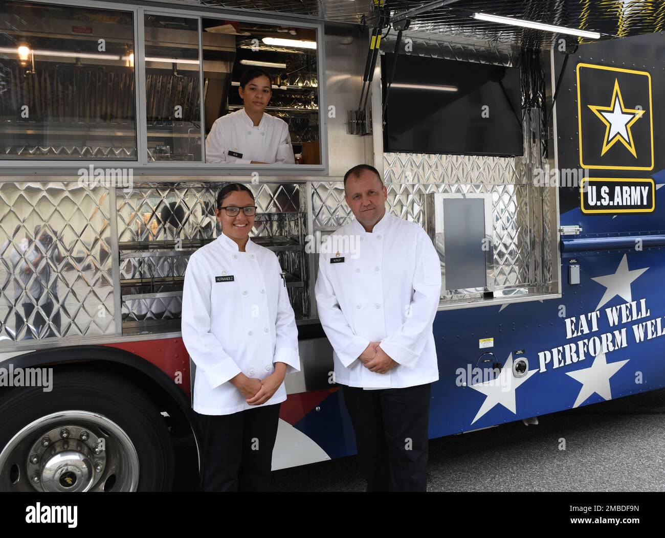 U.S. Soldiers pose outside their food truck at the Pentagon courtyard ...
