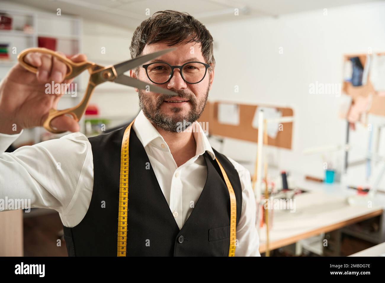 Professional tailor posing for camera at work Stock Photo - Alamy