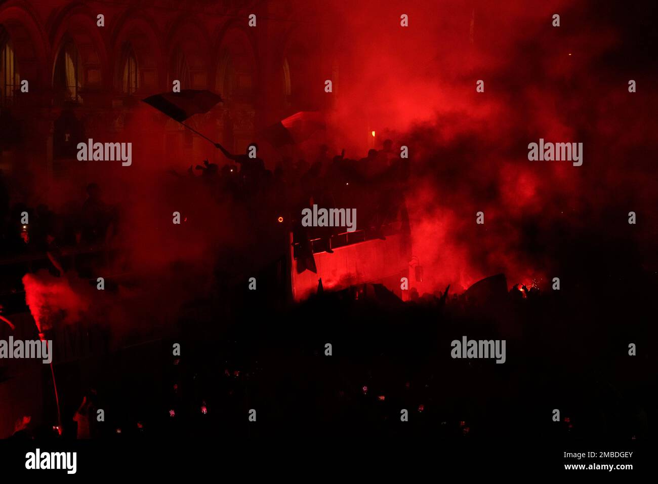 Thousands of fans cheer as a bus carries the triumphant AC Milan soccer ...