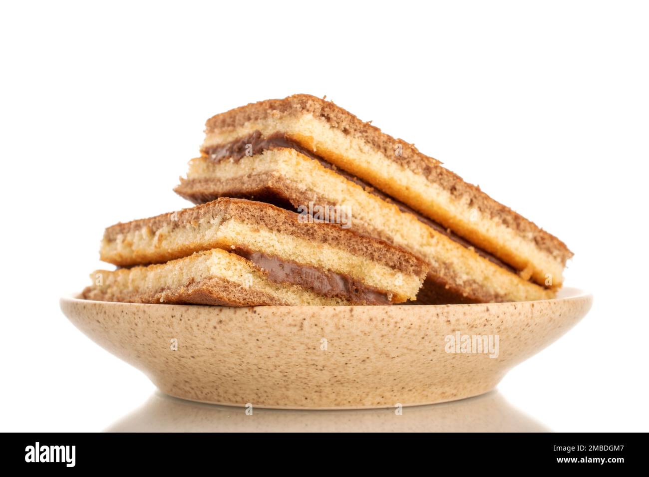Two mini biscuits with cocoa on a ceramic saucer, macro, isolated on ...