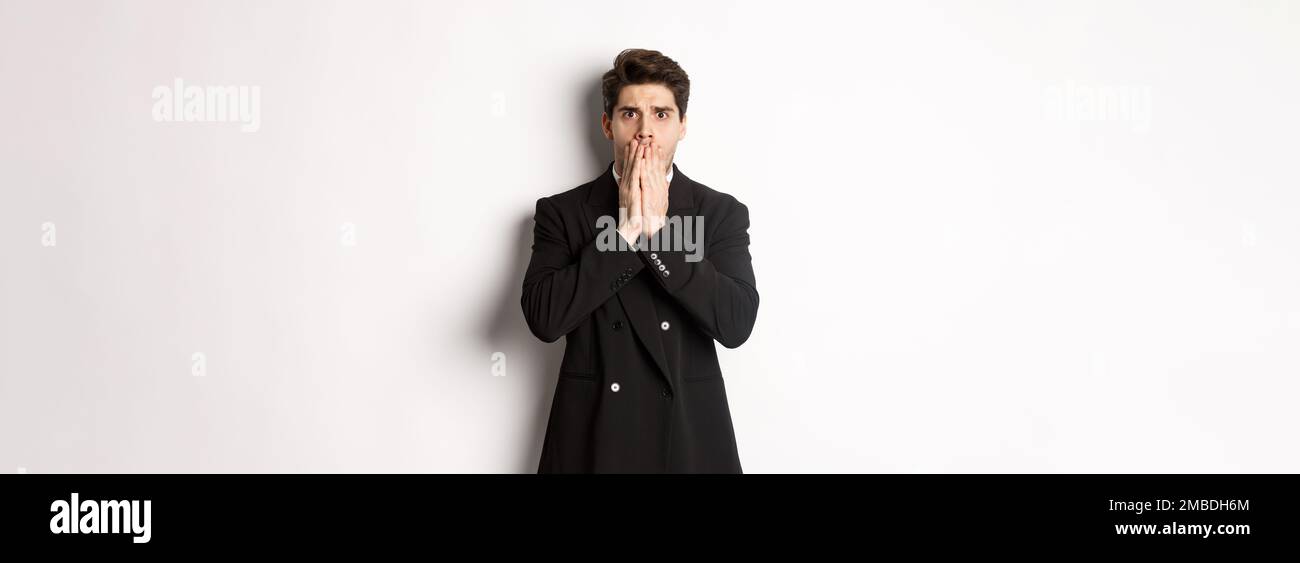 Portrait of shocked handsome businessman in suit, reacting to terrible ...