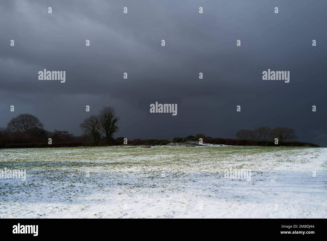 An approaching snow storm in fields near the village of Tregarth in ...