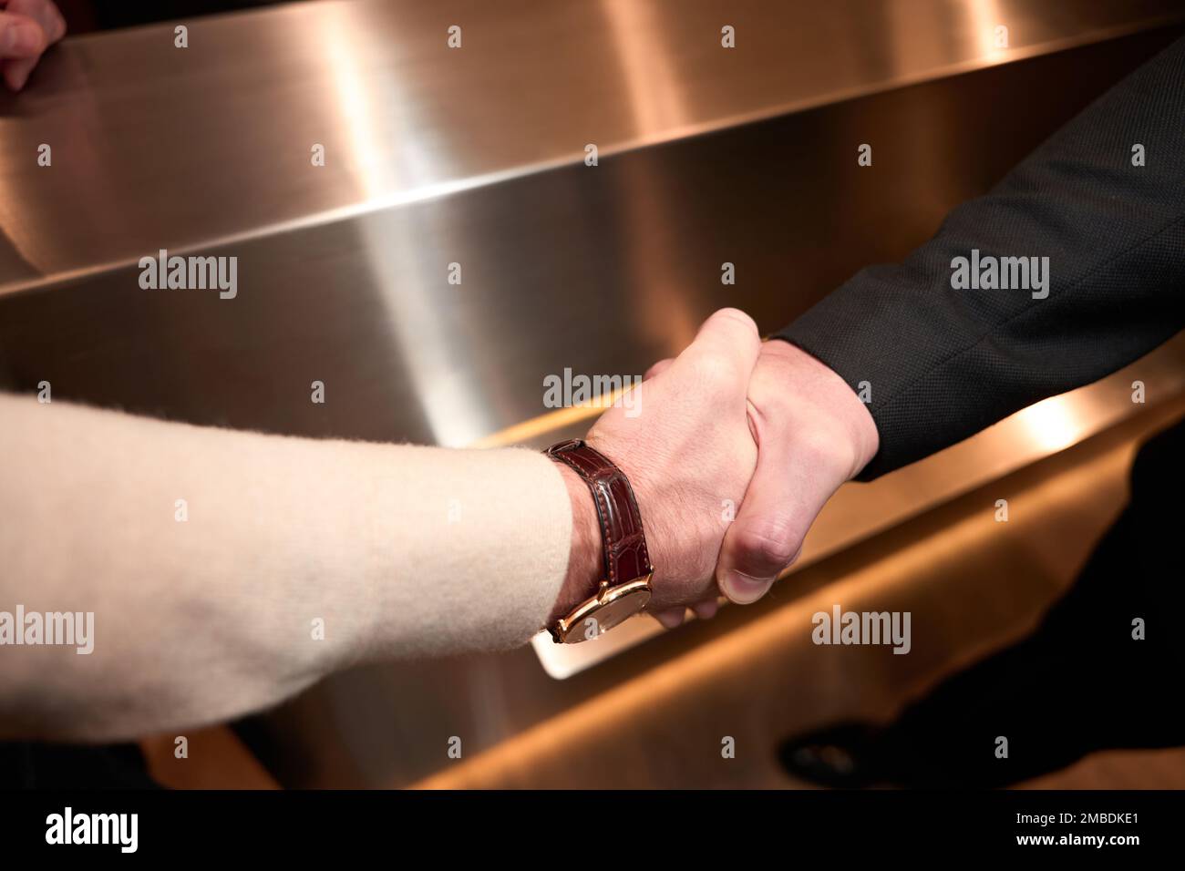 Real male handshake on the background of a metal surface Stock Photo ...