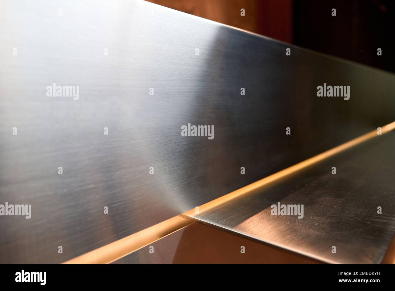 Shiny metal surface on the reception desk Stock Photo - Alamy