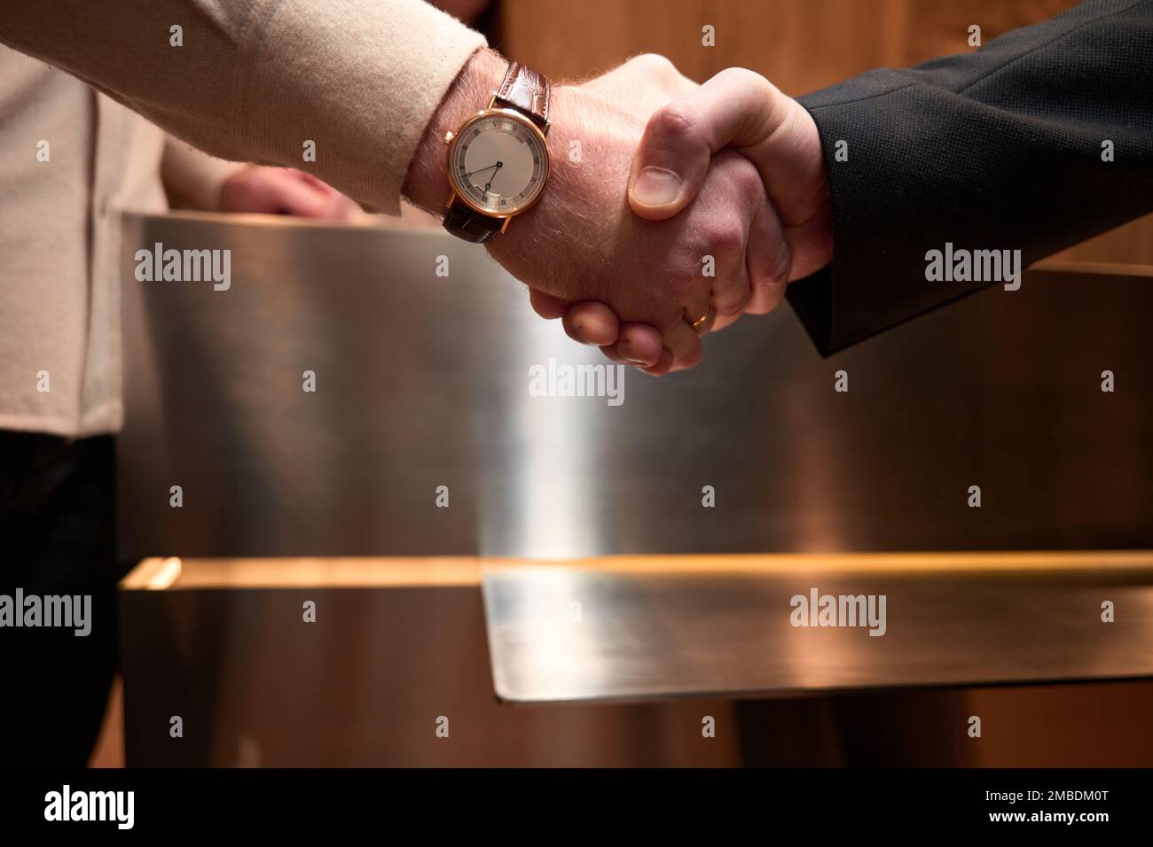 Strong male handshake on the background of a metal surface Stock Photo ...