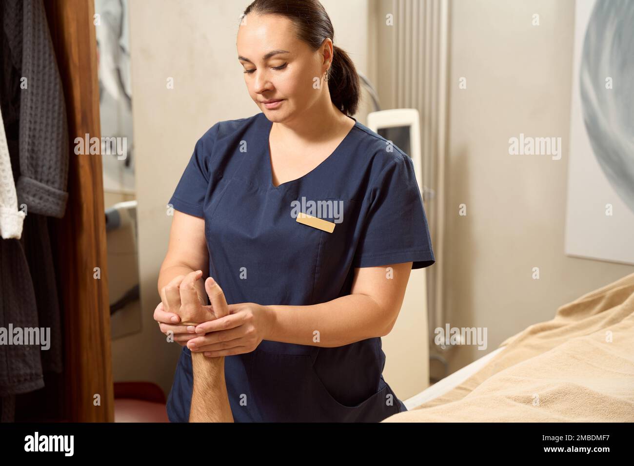 Specialist works with a patient in a massage room Stock Photo - Alamy