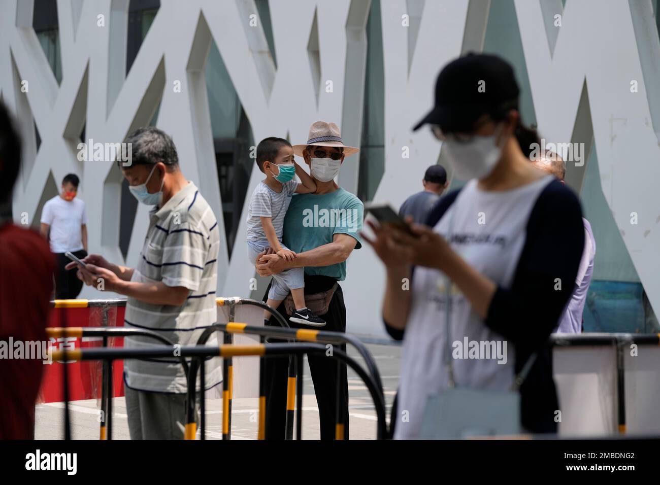 Residents line up for mass COVID test on Monday, May 23, 2022, in ...