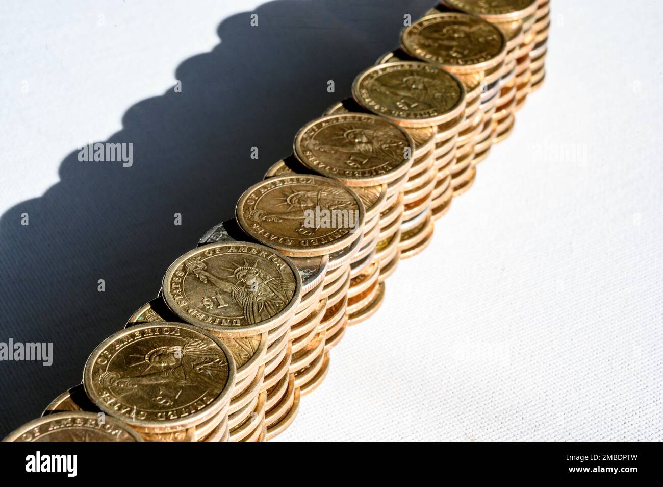 Stack of gold and silver dollar coins forming a border wall Stock Photo ...