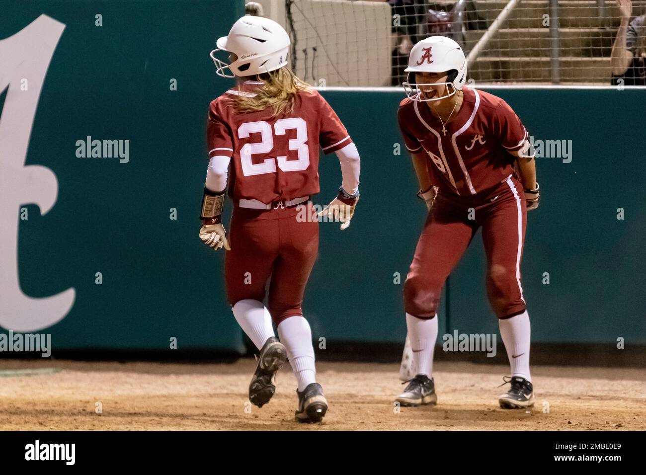 Alabama outfielder Jenna Johnson (88) greets Savannah Woodard (23) who ...