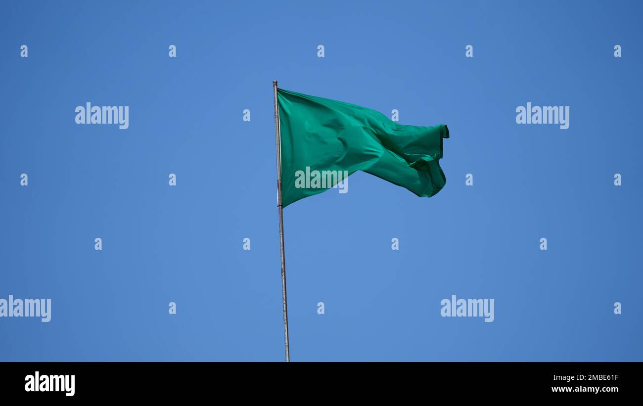 A green racing flag waives during practice for the IndyCar auto race at ...