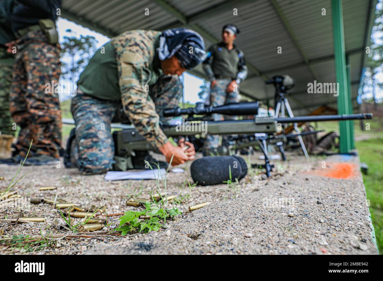 A Guatemalan sniper loads his rifle in preparation for the sniper skill ...