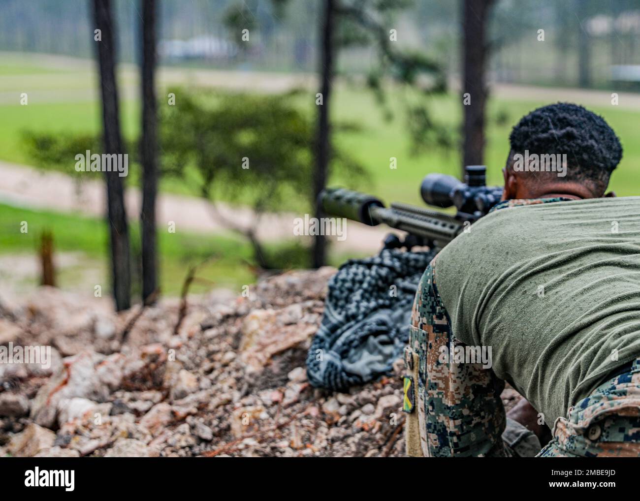 A Jamaican sniper looks through his scope to locate his target down ...