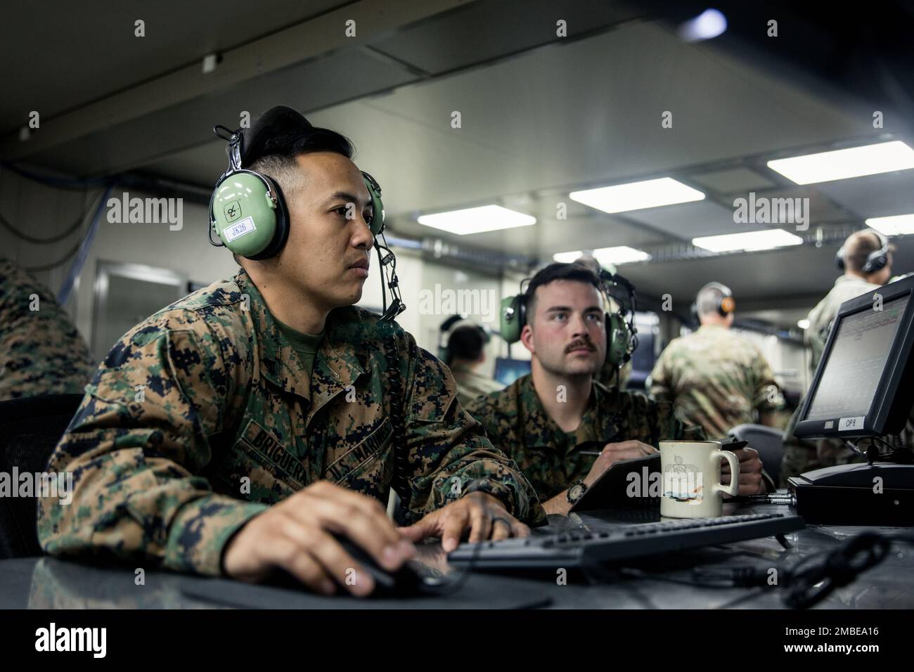 U.S. Marine Corps Cpl. Adonis Briguera, left, an operator controller ...
