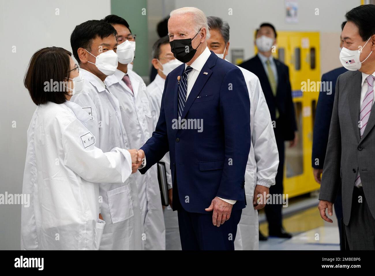 President Joe Biden is greeted by staff as he visits the Samsung ...