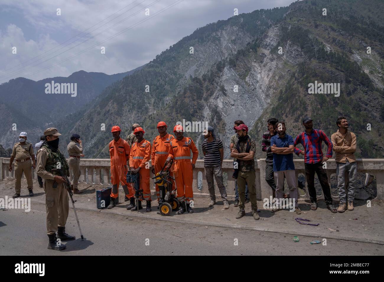 National Disaster Response Force (NDRF) members and villagers watch ...