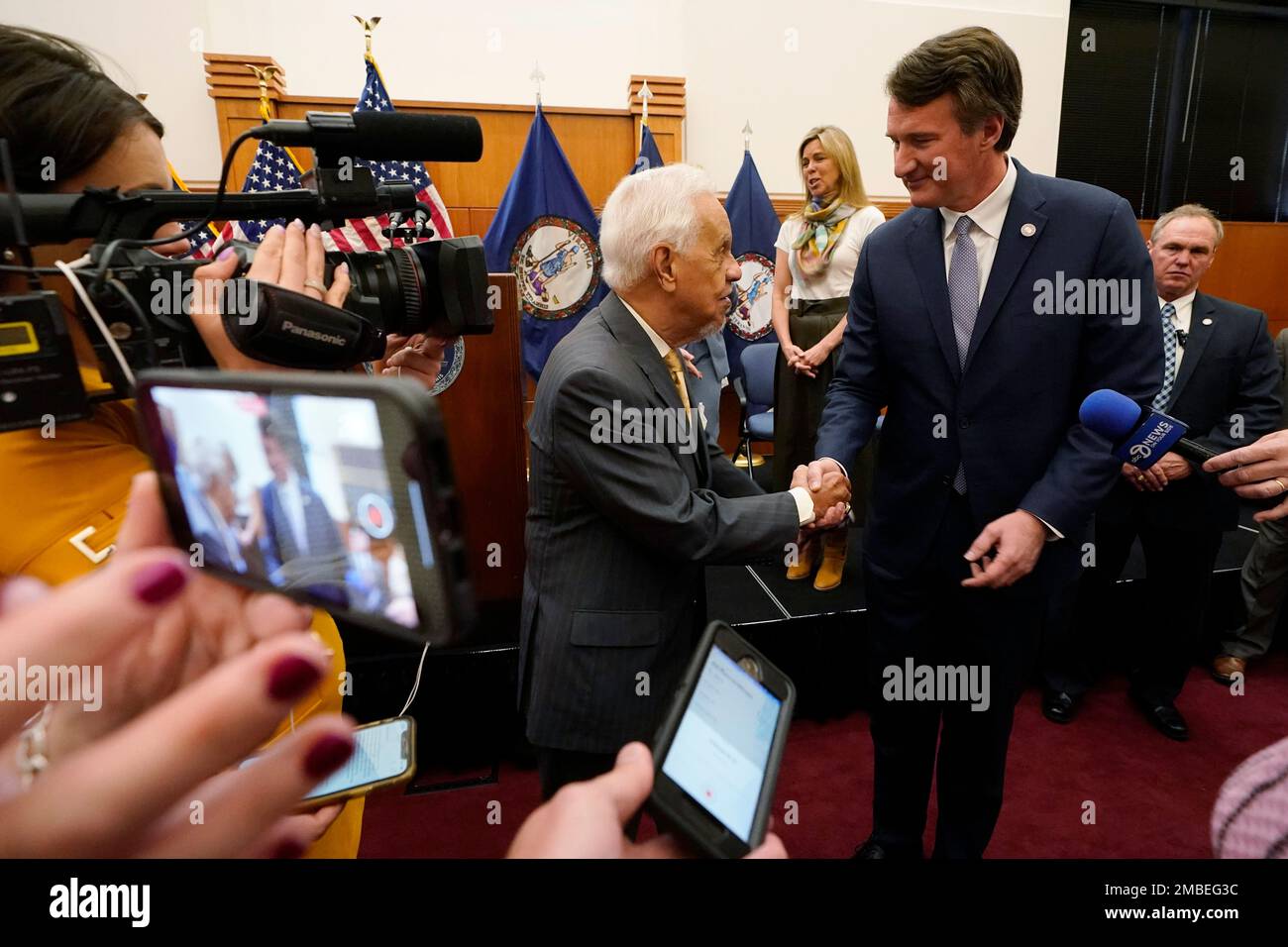 Virginia Gov. Glenn Youngkin, right, sakes the hand of former Gov.L ...