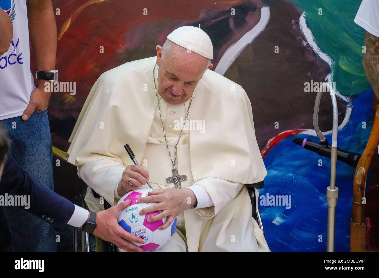 Pope Francis signs a soccer ball at the launch of the 'Scholas ...