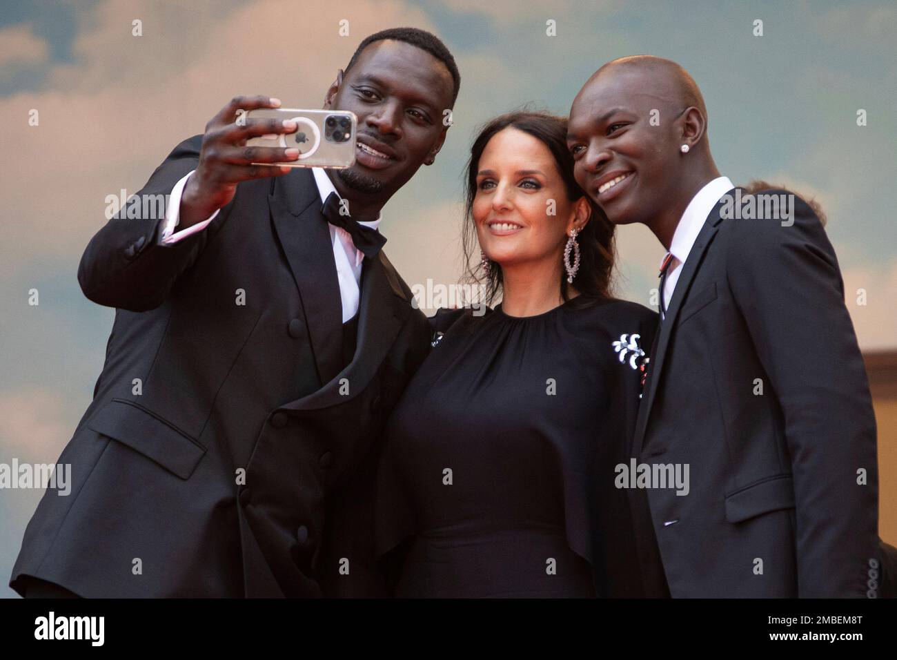 Omar Sy, Helene Sy and Alassane Diong pose for a selfie upon arrival at ...