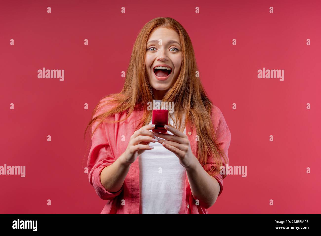 Pretty woman got jewelry box with proposal diamond ring on pink wall ...