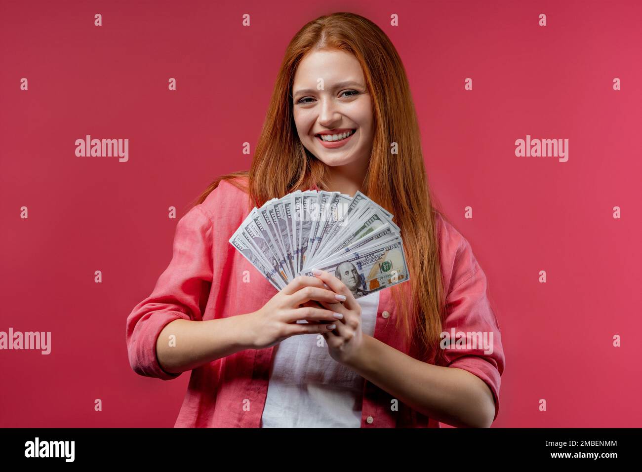 Rich excited ginger woman with cash money - USD currency dollars ...