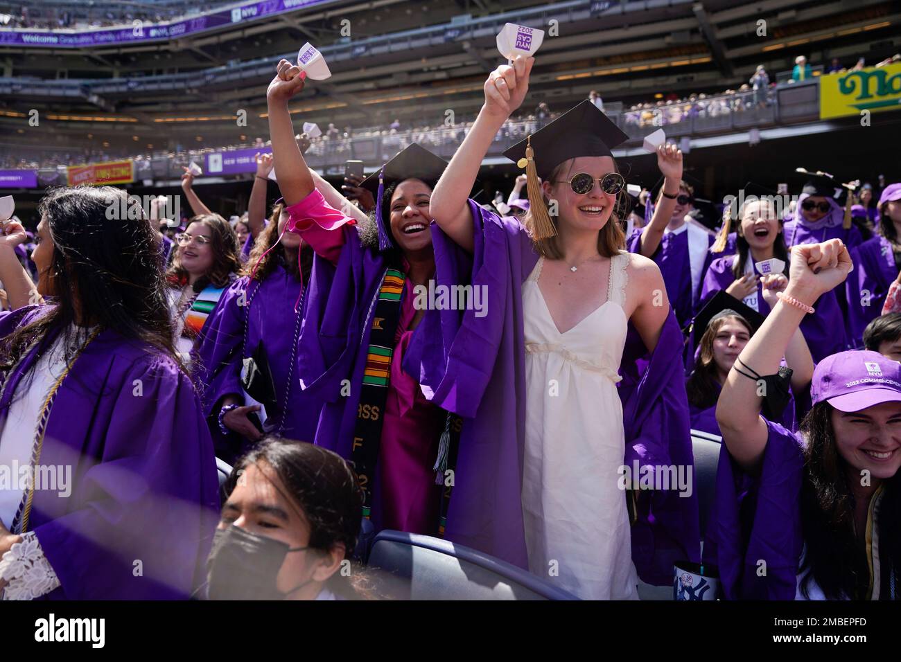 Graduates cheer during a graduation ceremony for New York University at ...