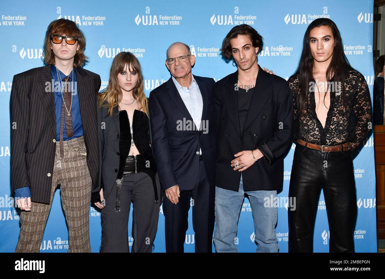 Honoree Scott Greenstein, center, poses with the Italian rock band ...