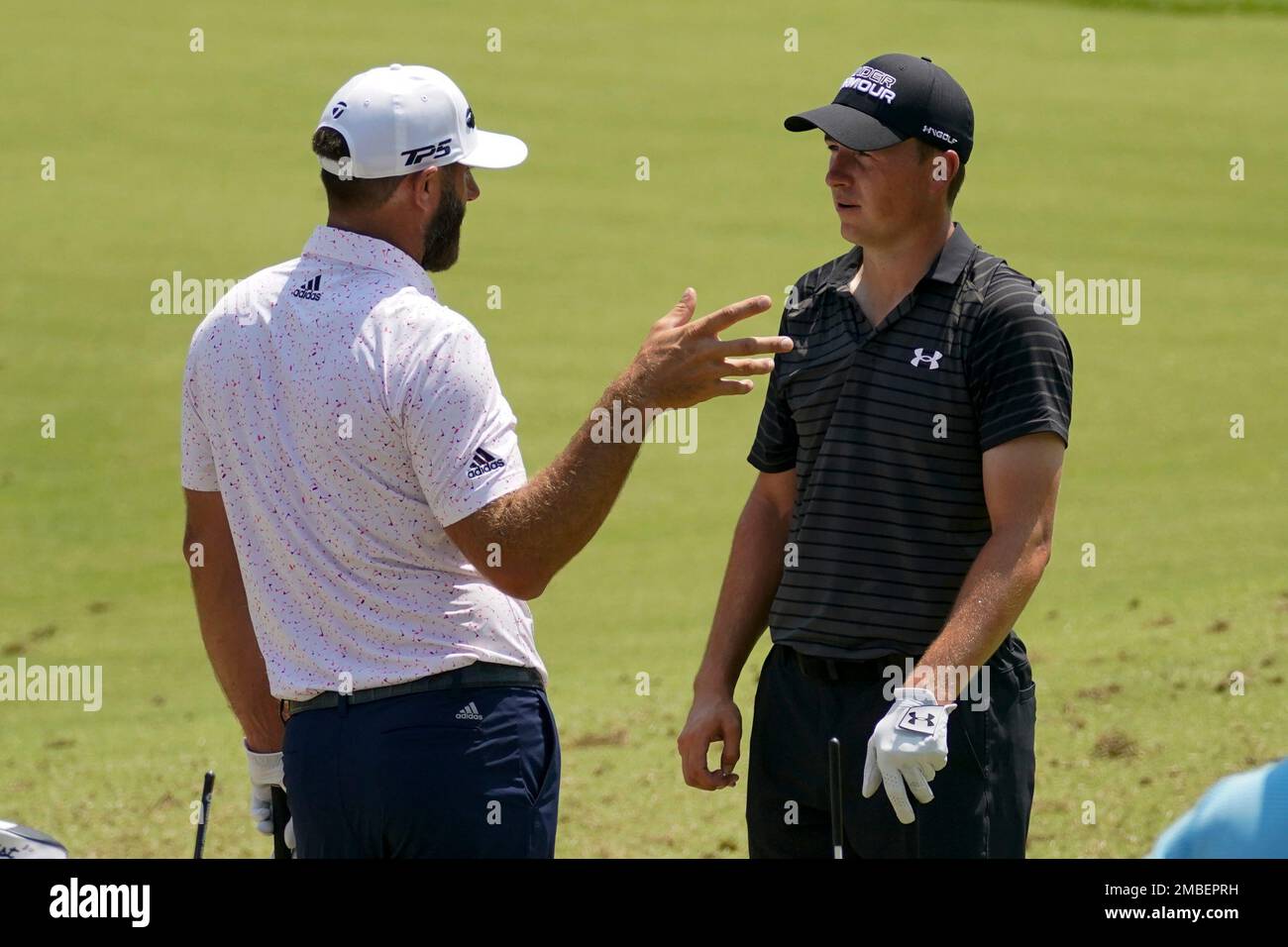 Dustin Johnson and Jordan Spieth talk on the driving range before a ...