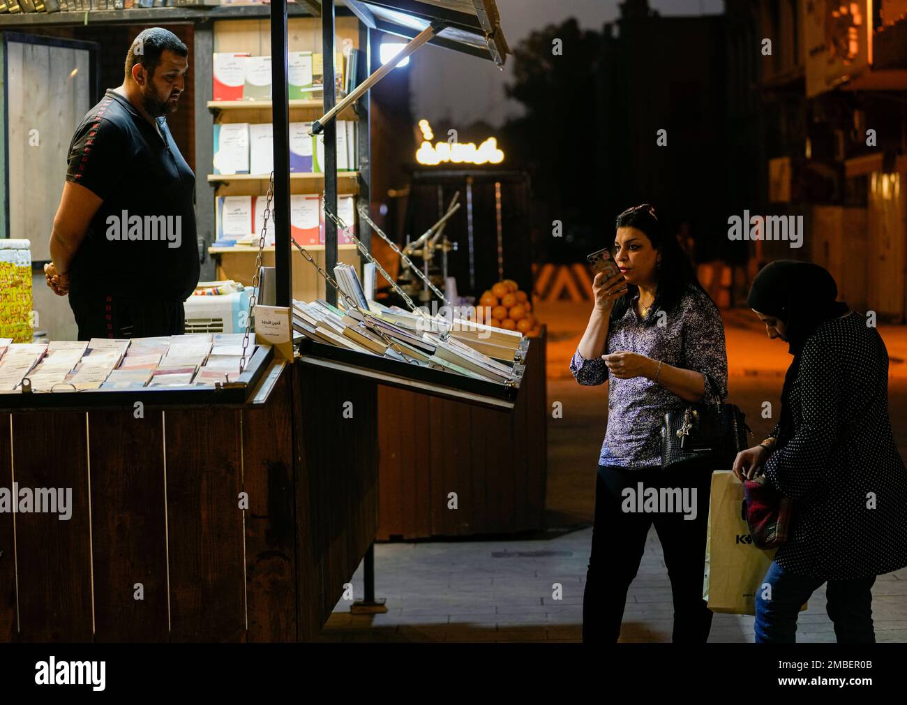 Iraqis walk through the book market in the Mutanabi Street of Baghdad ...