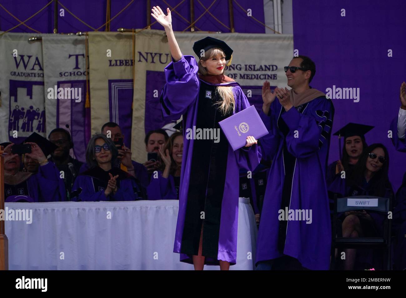 Taylor Swift waves after receiving an honorary degree during a ...