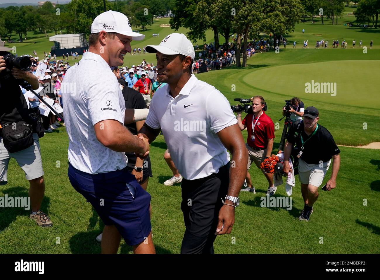 Bryson Dechambeau greets Tiger Woods after a practice round for the PGA ...